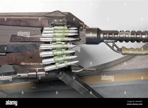 A Tape With Large Caliber Bullets Is Loaded Into A Machine Gun Large