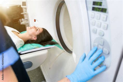 Ct Scan Technologist Overlooking Patient In Computed Tomography Scanner