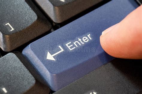 man pressing a blue enter key on a laptop computer keyboard hand