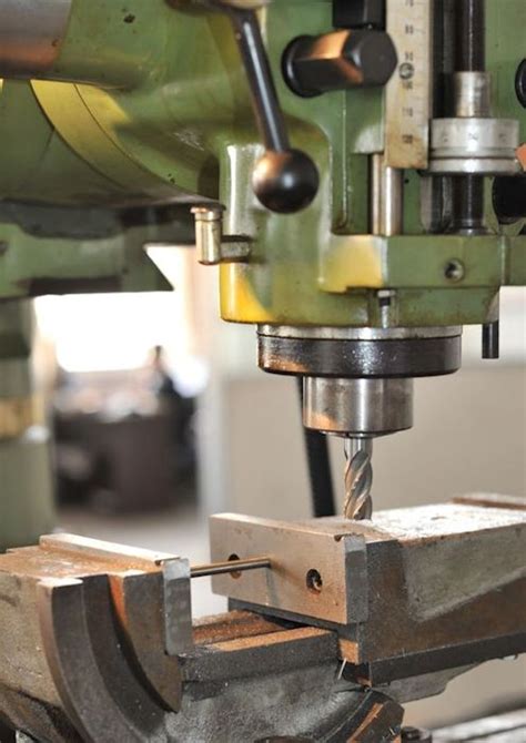 Mounted Drill Making A Hole In A Piece Of Lumber