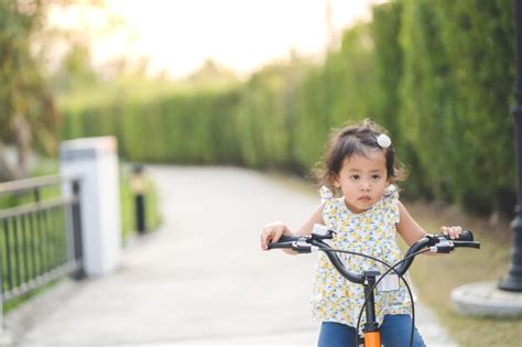 Premium Photo Portrait Of Cute Girl Riding Bicycle