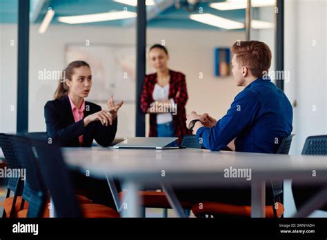 A Team Of Successful Programmers Sits In A Startup Office Strategizing New Business Projects