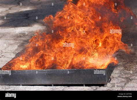 A Pan With Fuel On Fire At A Fire Fair Safety Demonstration Stock Photo Alamy