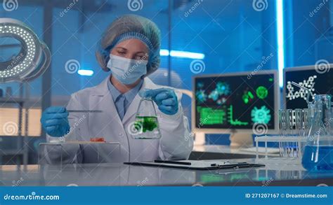 A Female Scientist Observes The Dissolution And Spread Of A Green