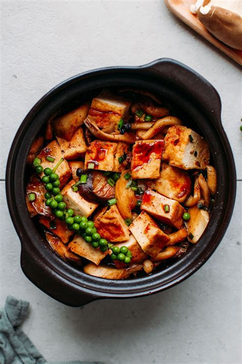 Braised Tofu And Mushrooms In Clay Pot Full Of Plants