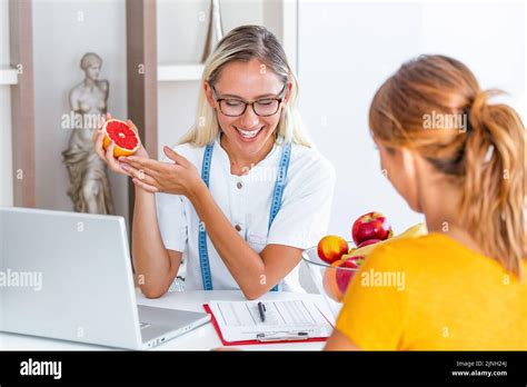 Doctor Nutritionist Dietician And Female Patient On Consultation In