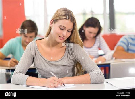Female Babe Writing Notes In Classroom Stock Photo Alamy