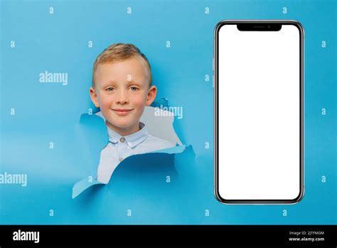 Happy Cute Boy Is Having Fun Played On Blue Background Wall Climbs