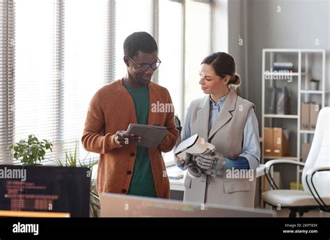 Smiling Developer Asking Woman With Prosthetic Arm To Wear Vr Headset For Testing New