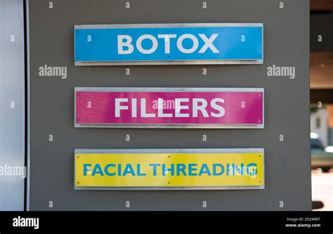 Botox Fillers And Facial Threading Advertised On The Window Of A Clinic