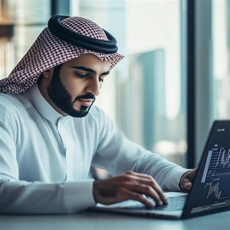 A Saudi Data Engineer Analyzing Data On His Laptop In A Corporate
