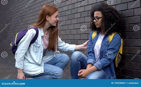 Smiling College Student Encouraging New Classmate Taking Hand Help Assistance Stock Image