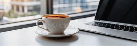 Organized Workspace Featuring Laptop Coffee Cup And Notebook For