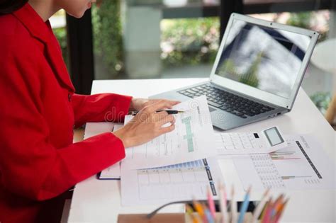 Business Woman Using A Calculator To Calculate Personal Income Tax