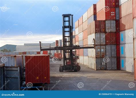 Forklift Truck Handling Cargo Container Boxes In Logistic Delivery Yard With Stacks Of Cargo