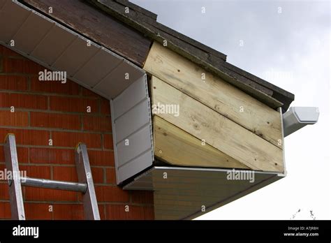 Section Of Fresh Wood Repairs During Installation Of White Pvc Cladding