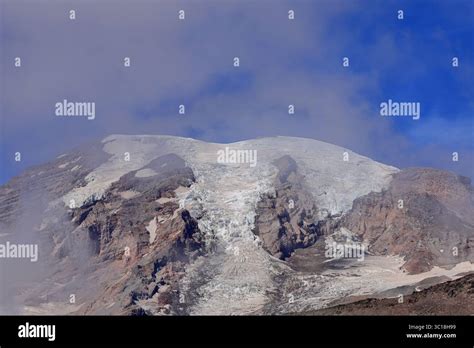Misty Clouds Swirl Over Rugged Talus Slopes And Residual Glacier Ice