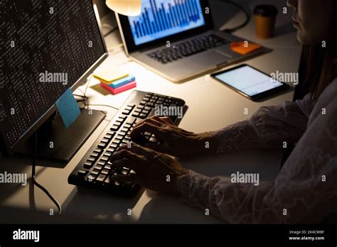 Hands Of Biracial Female Programmer Sitting At Desk Using Computer