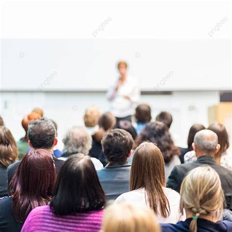 A Female Lecturer Conducting A Presentation At A University Lecture Hall Photo Background And