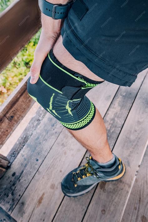 Premium Photo Adult Runner In A Park Wearing An Elastic Brace For A