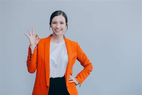 A Young Asian Woman With A Happy Successful Expression Wearing White