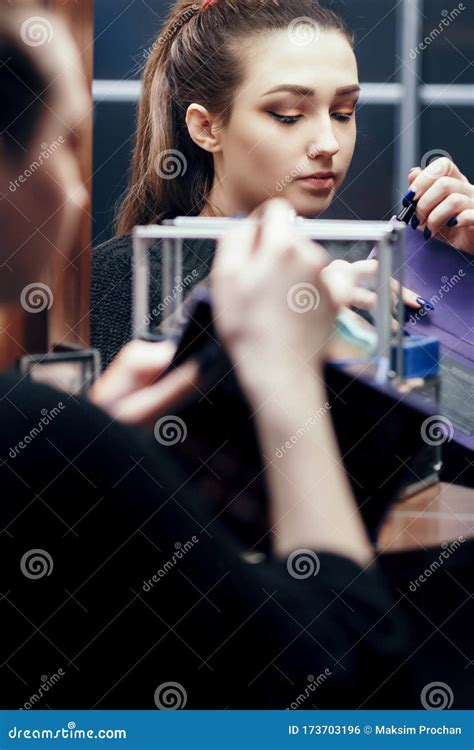 Reflection Of A Beautiful Girl In The Mirror Doing Makeup At The