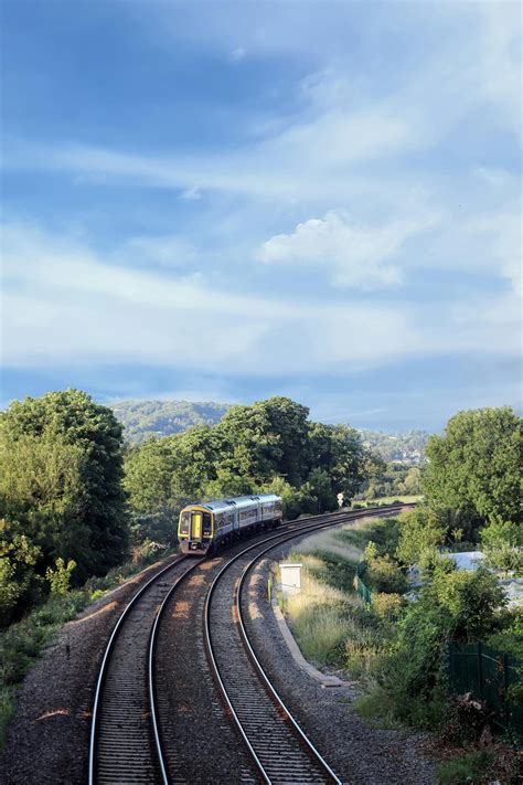 집 밖의 강철 궤도 경로 경치 경치가 좋은 곡선 트랙 교통 교통체계 구름 금속 레일 기관차 기차 기차 선 기찻길 나무 녹색 단풍 농촌의 대중