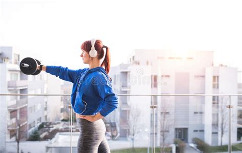 Redhead Woman S Home Workout Routine With Dumbbell At Balcony Home