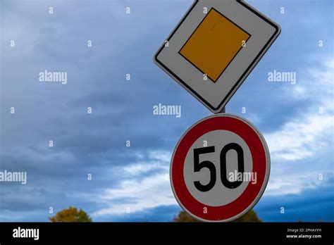 road sign with 50 kroad sign with 50 kmh and right of way, Germany in ...