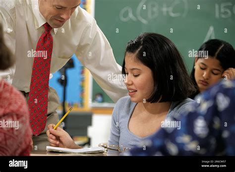 Pupil Being Helped By Her Teacher In A Middle School Classroom Stock Photo Alamy