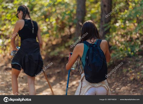 Sisters Hiking Beautiful Woods While Wearing Backpack Enjoying Nature
