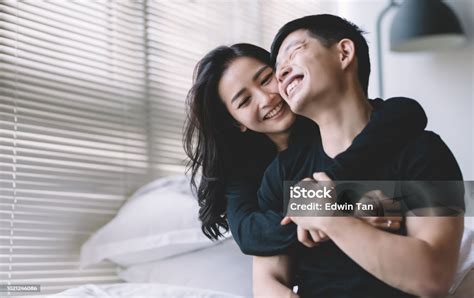 Asian Chinese Couple Having Bonding Time On Bed In The Morning During