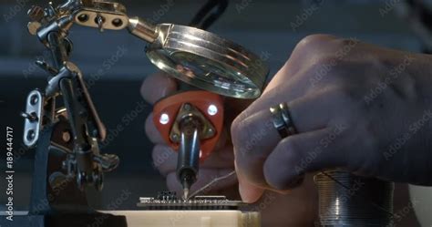 Hobbyists Hands Soldering An Electrical Connection On Circuit Board With A Hot Soldering Iron