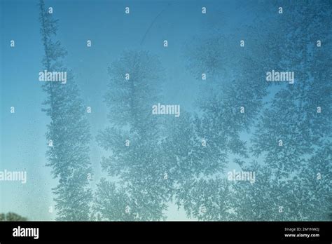 Frost Patterns On Glass Window Pane Frosted Glass With Blue Sky Behind