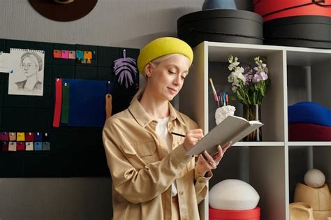 Premium Photo Young Blond Woman With Notebook Making Notes Or Drawing