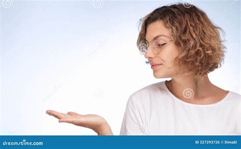 Woman Holding Out Her Hand For Product Display On Light Blue Background