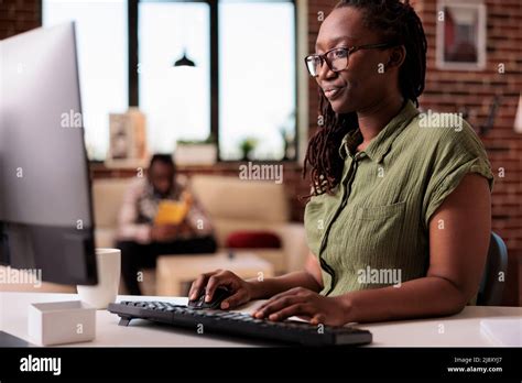 Focused African American Programmer Working Remote From Home While