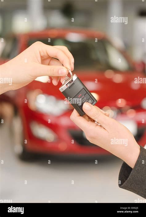 Female Hand Getting Modern Car Key On A Red Car Background Stock Photo Alamy
