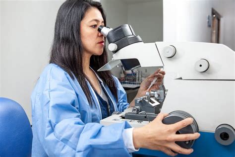 Young Female Scientist Using An Ultramicrotome To Make Sections For The
