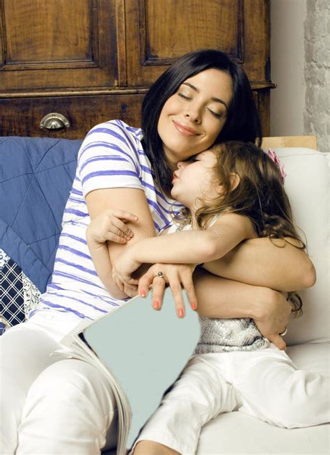 Portrait Of Mother And Daughter Laying In Bed And Smiling Close Stock