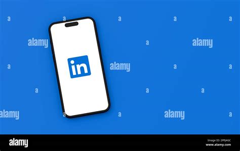 linkedin logo on mobile phone screen on flat blue background with copy