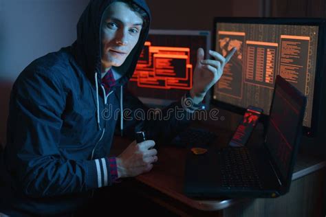Man In The Hood Looking In The Camera Hacker Attacks And Stealing Access Databases With