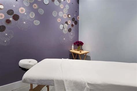 Download A Massage Room With Purple Walls And A White Bed