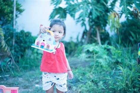 Premium Photo Portrait Of Cute Girl Standing In Park