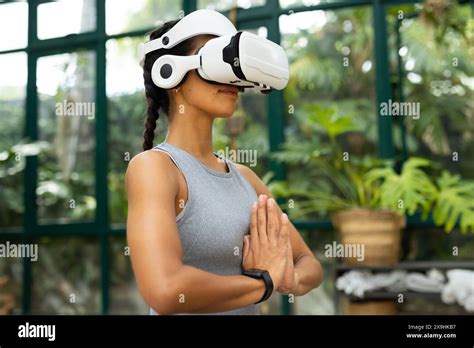 Pacific Islander Female Yoga Instructor Uses Vr Headset At Glass House