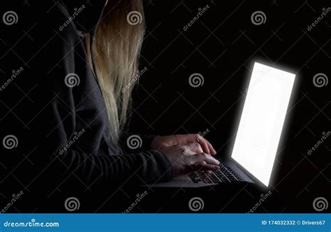 Overhead Hacker In The Hood Working With Laptop And Mobile Phone Typing Text In Dark Room Stock