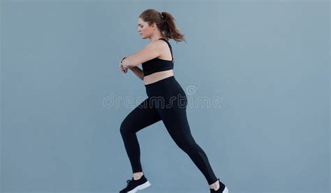 Young Woman With Plus Size Body Type Jogging And Looking At Her