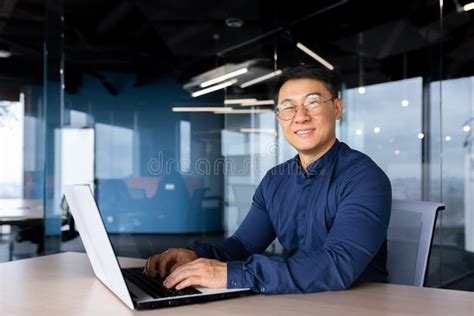 Successful Asian Businessman Smiling And Looking At Camera Programmer Porter Inside Office