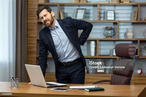 The Problem Of Sedentary Work A Young Businessman Man In A Suit Stands