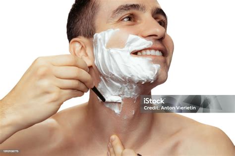 하얀 스튜디오 배경에 고립 된 크림과 면도기로 면도하는 얼굴을 가진 젊은 웃는 남자의 초상화 매끄러운 피부 35 39세에 대한 스톡 사진 및 기타 이미지 Istock